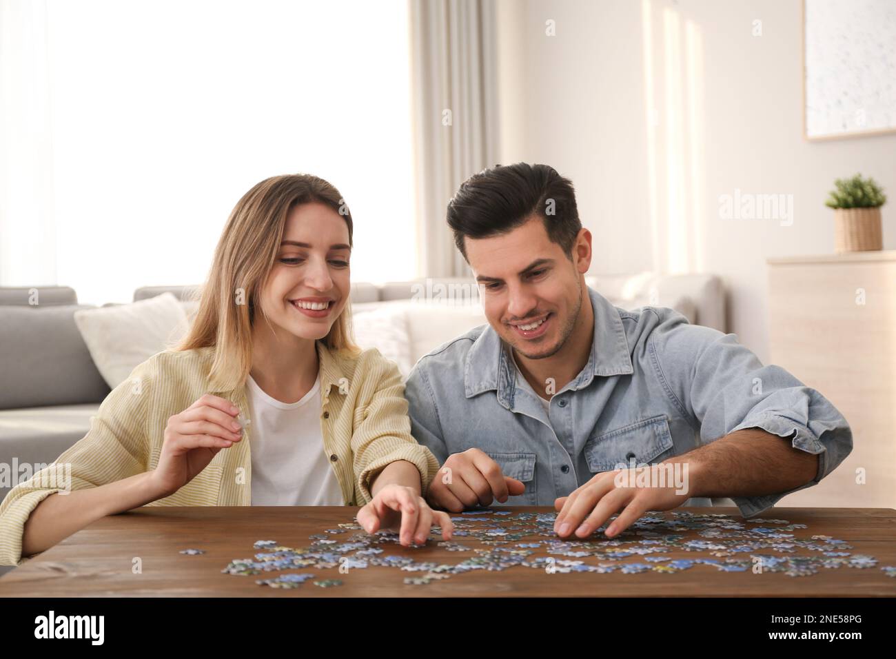 Playing with puzzles hi-res stock photography and images - Alamy