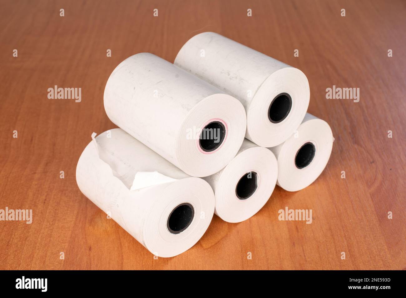 Several paper rolls of cash register tape on office desk, close up ...