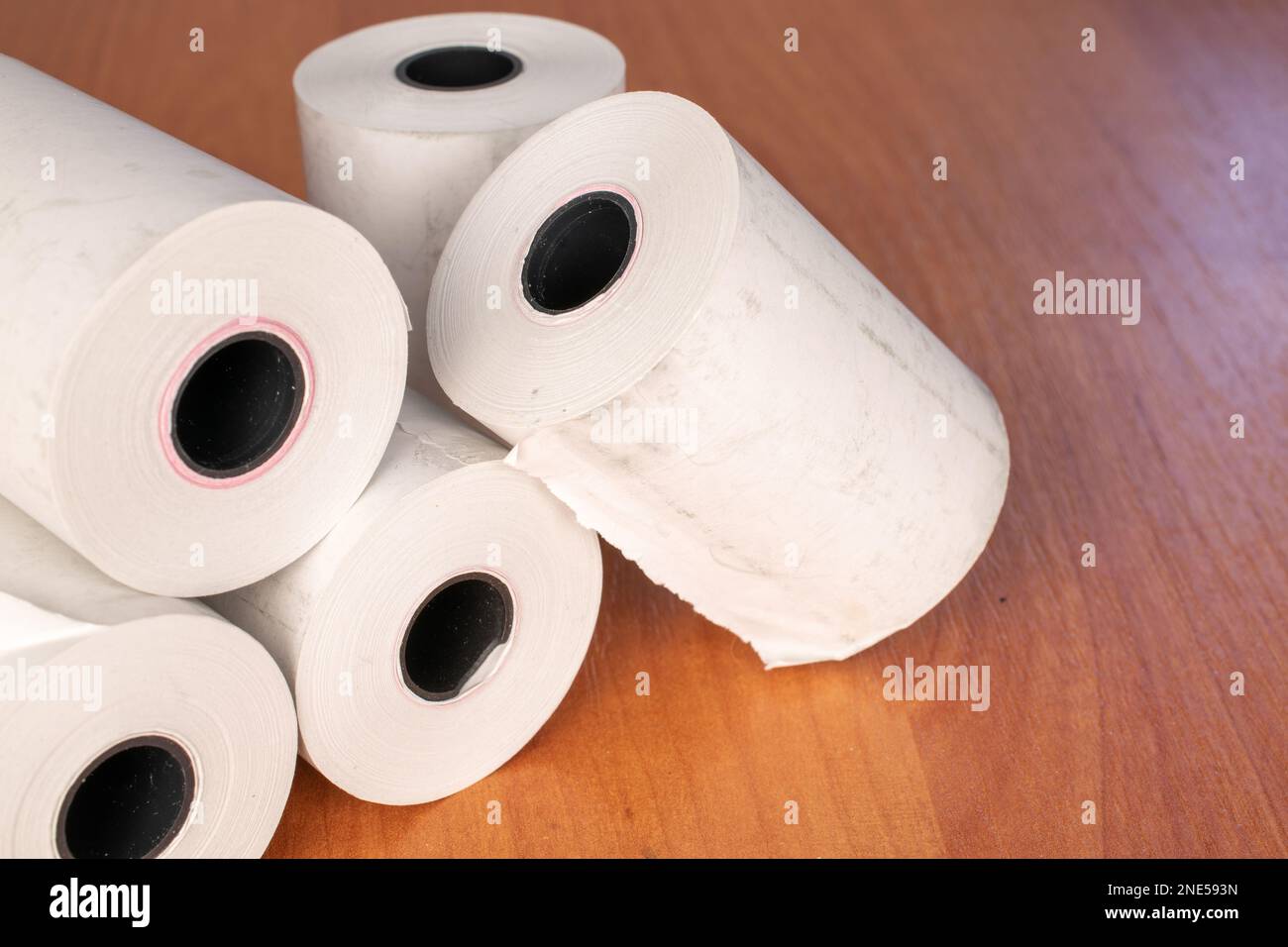 Several paper rolls of cash register tape on office desk, close up ...