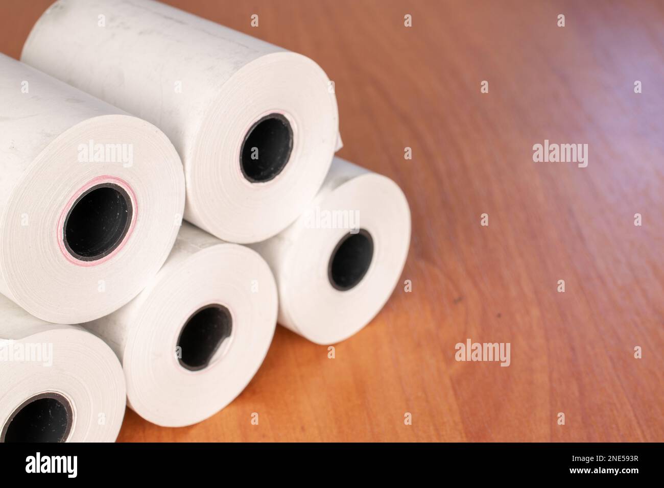 Several paper rolls of cash register tape on office desk, close up ...