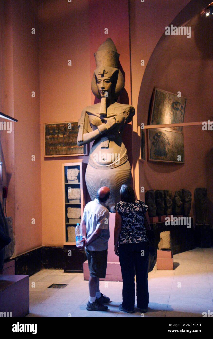 Tourists view the colossus of Pharaoh Akhenaten in the Egyptian Museum ...