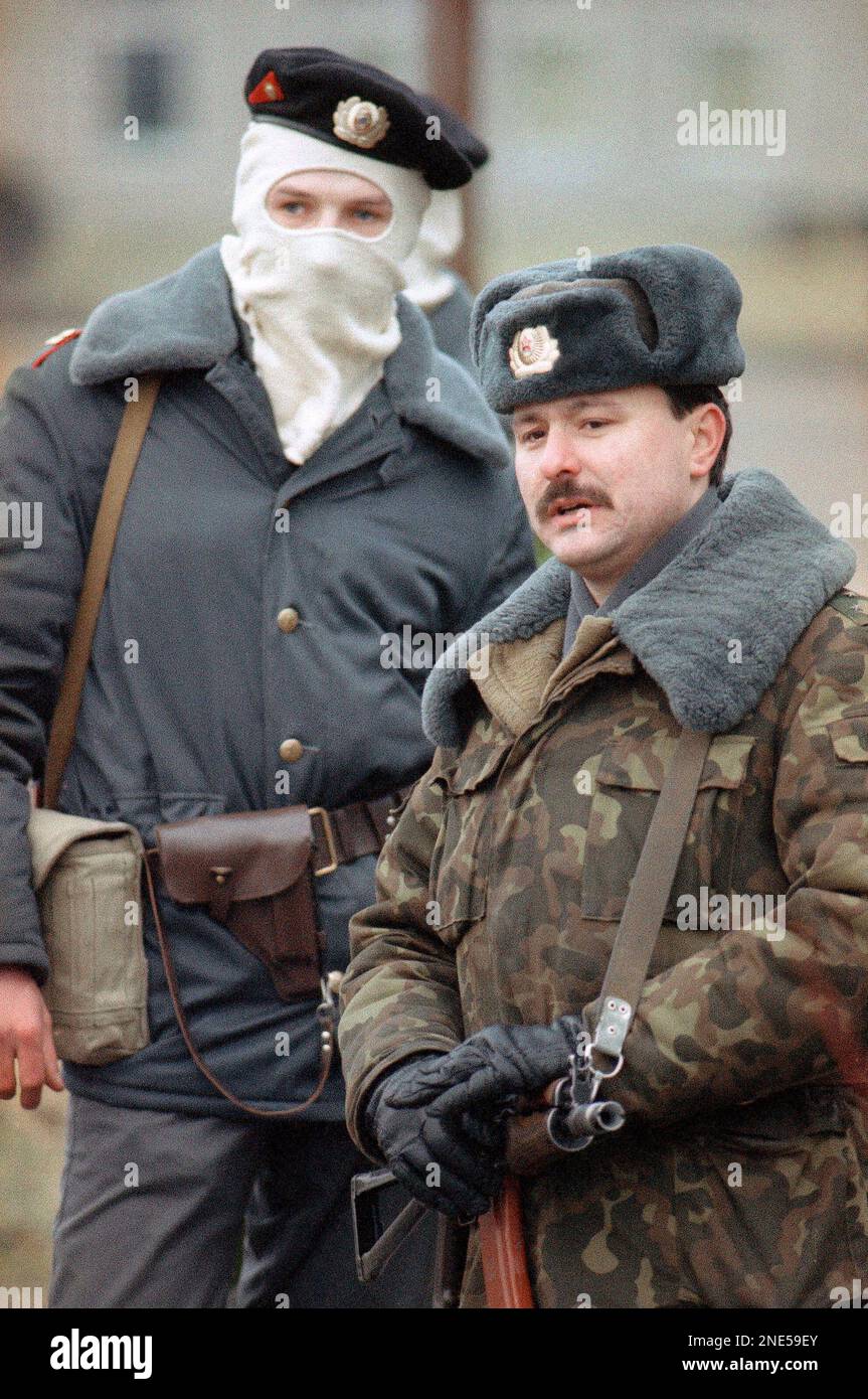 A Soviet army soldier yielding their ak-47 and a masked national ...