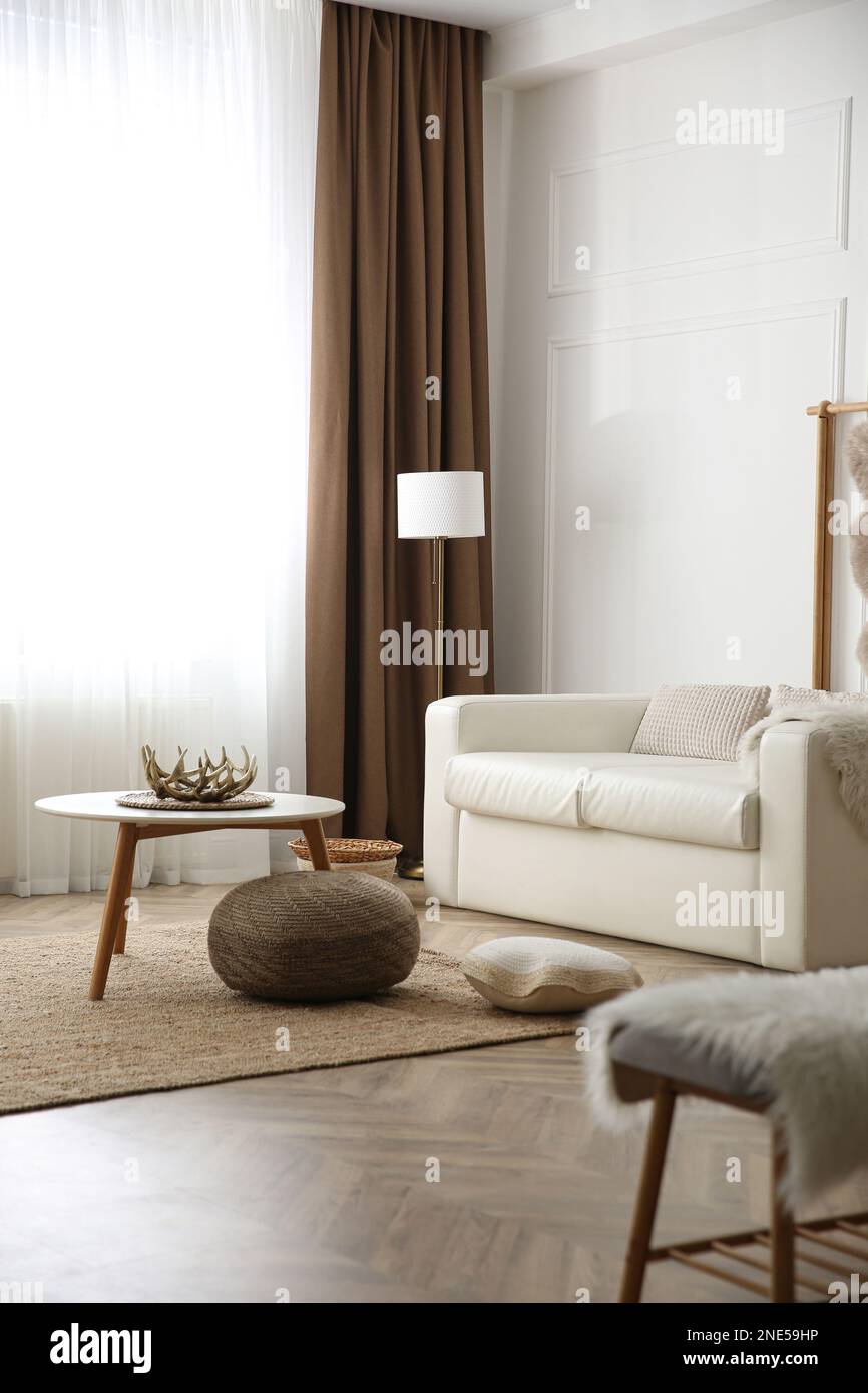 Table and comfortable sofa in modern room. Interior design Stock Photo ...