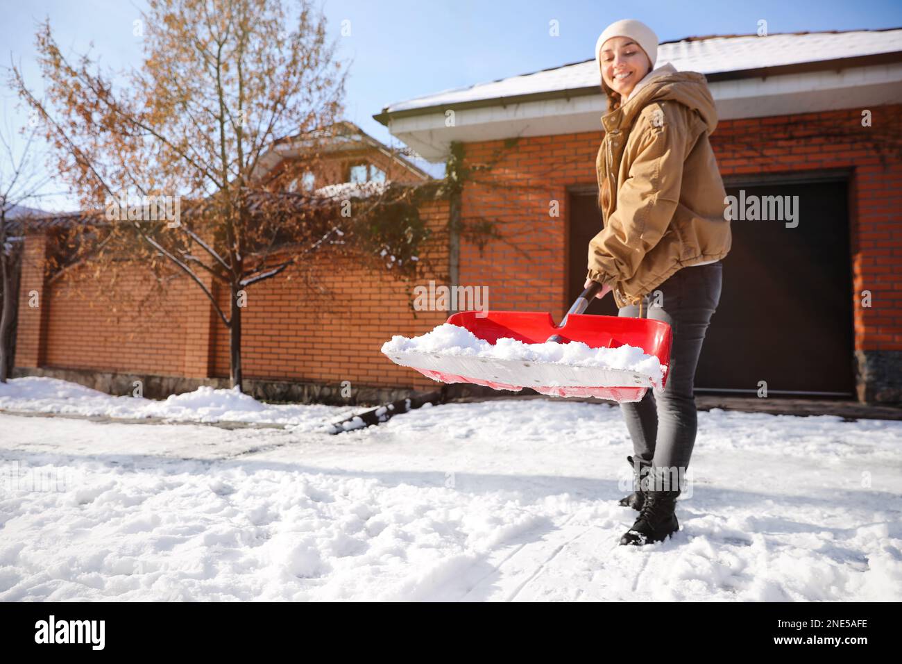 Woman shoveling snow hi-res stock photography and images - Alamy