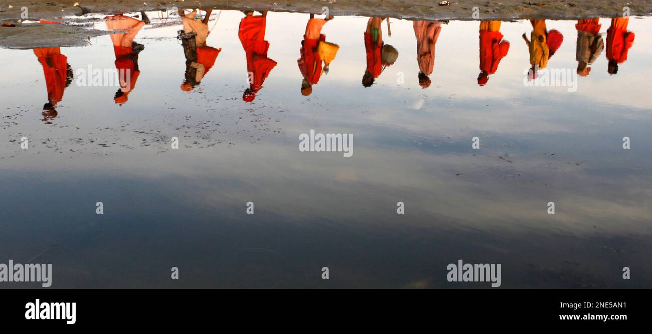 Hindu holy men arriving on the banks of the Ganges River for a holy dip ...