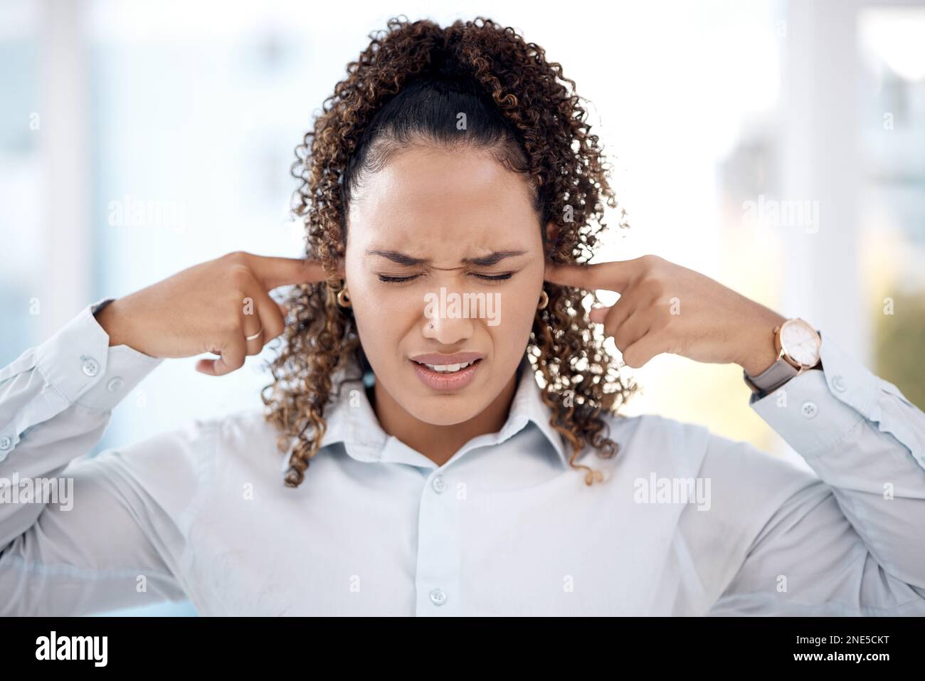 Noise, loud and woman closing her ears for the sounds in the office ...