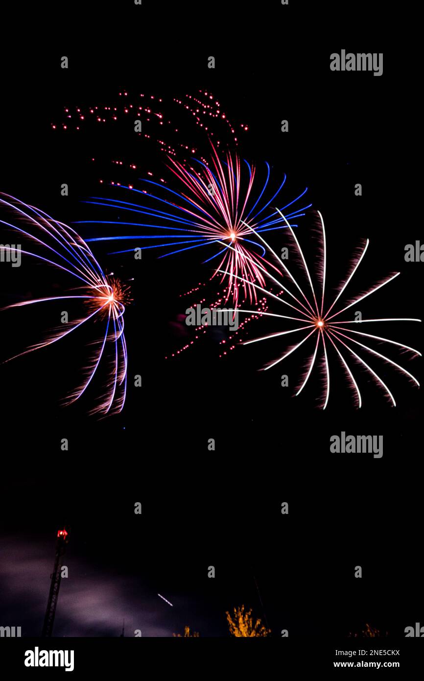 Vertical image of a fireworks display with wind affecting the ...
