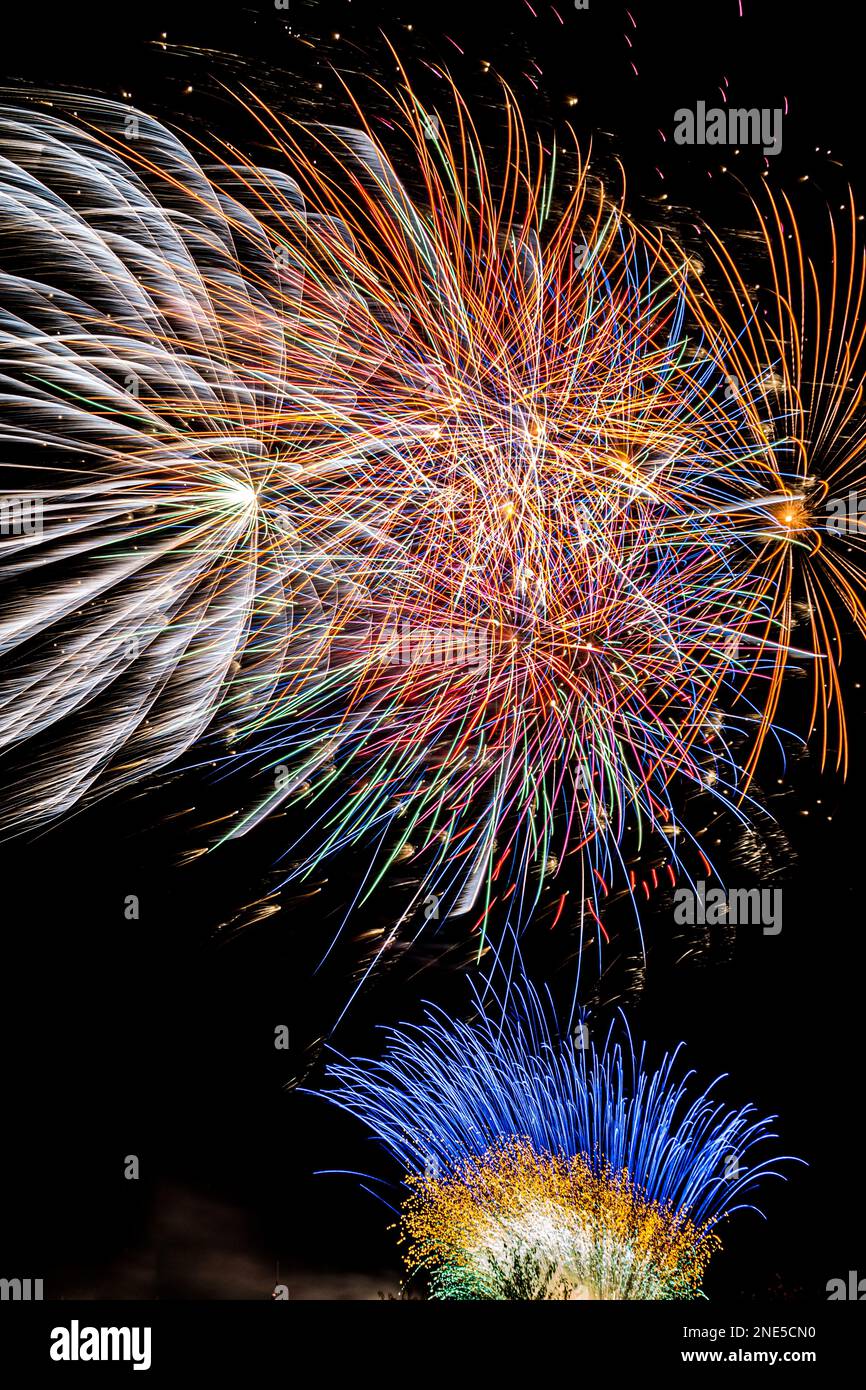 Vertical image of a fireworks display with wind affecting the ...