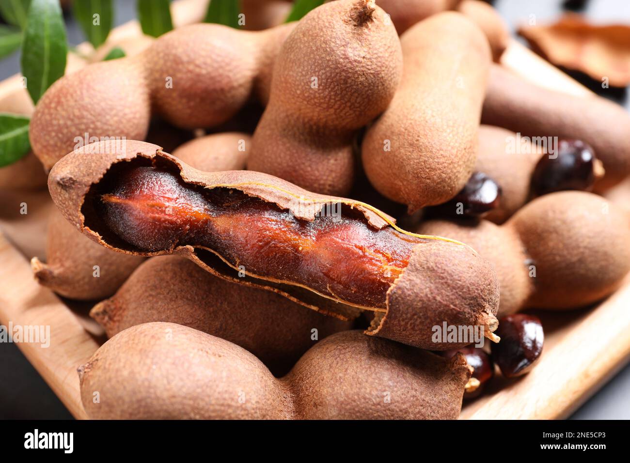 Delicious ripe tamarinds on wooden plate, closeup Stock Photo - Alamy