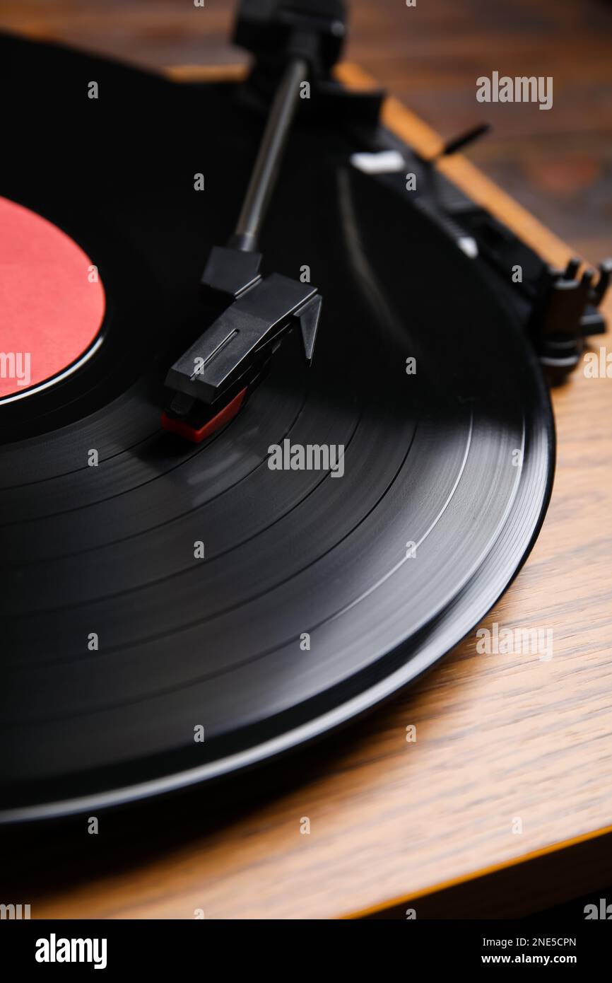 Modern vinyl record player with disc on table, closeup Stock Photo - Alamy