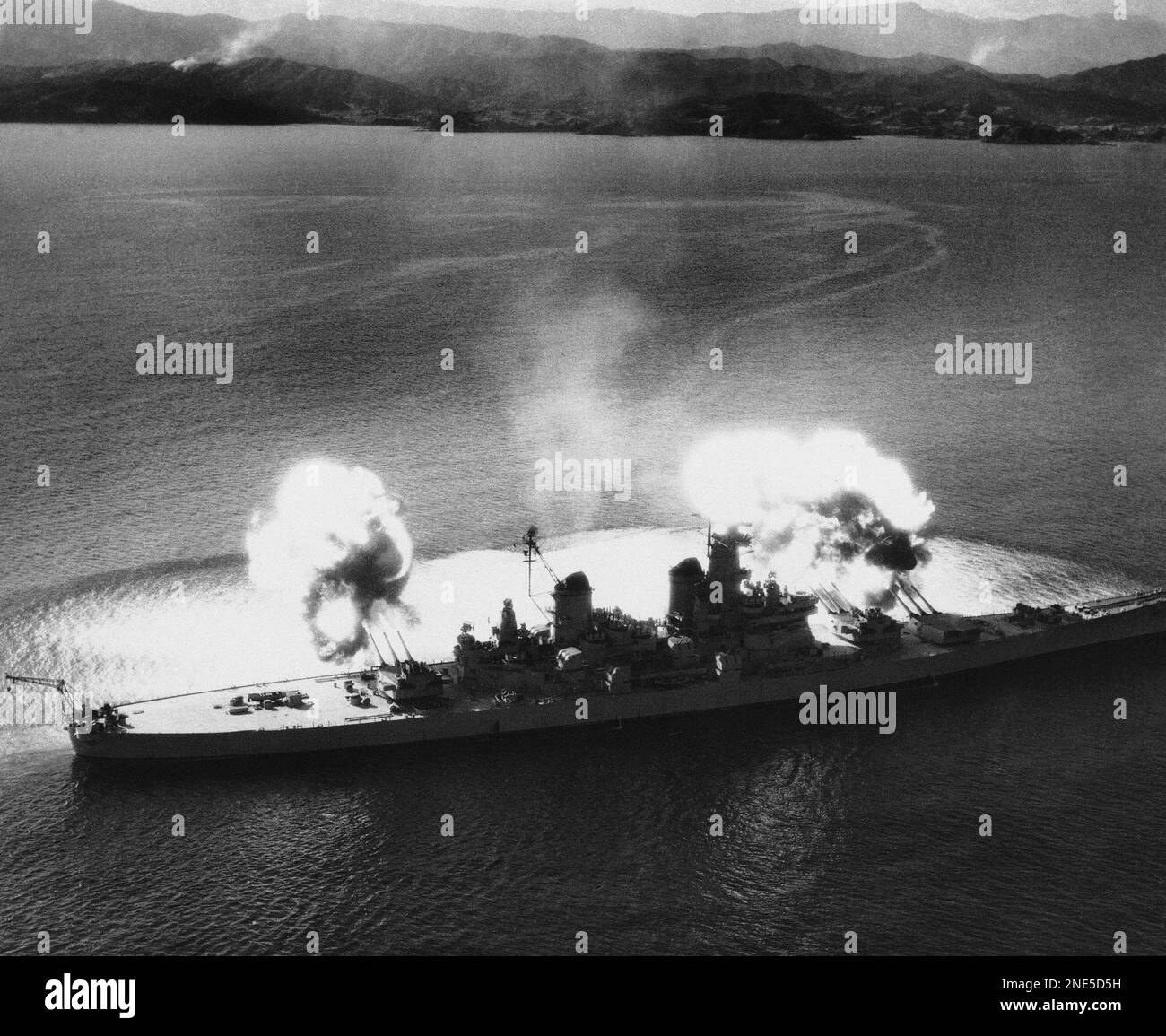 The battleship USS New Jersey lets go with a salvo from nine of her 16 ...