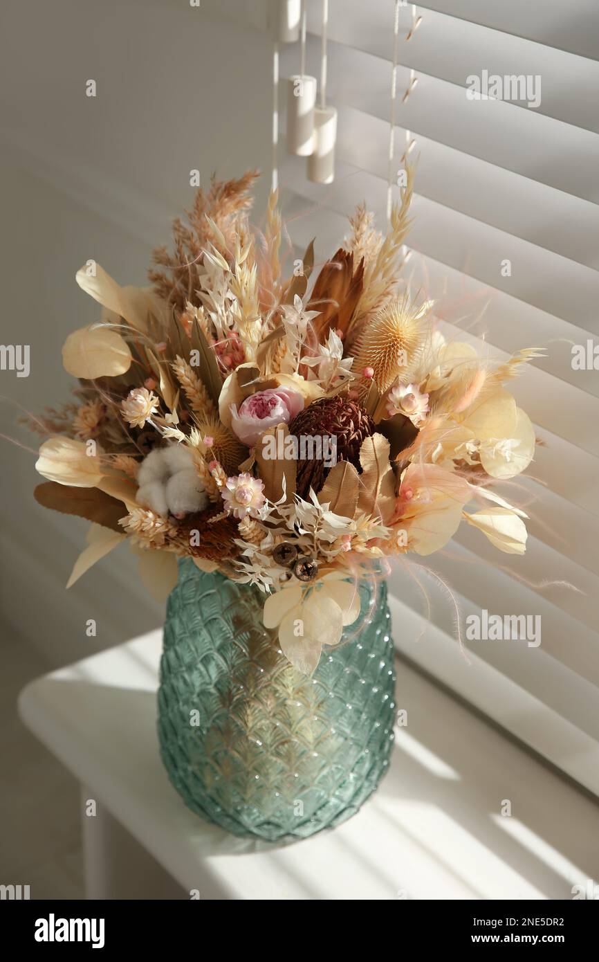 Beautiful dried flower bouquet in glass vase on white windowsill Stock ...