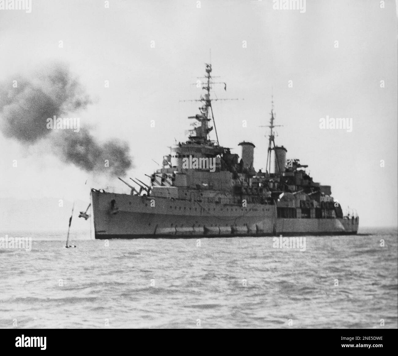 H.M.S. Belfast firing a six inch salvo against enemy troop ...