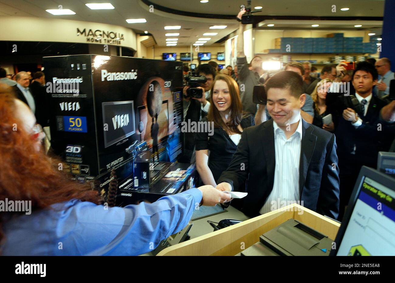 Brad Katsuyama, holding receipt, and wife Ashley, become the world's first consumers to purchase ...