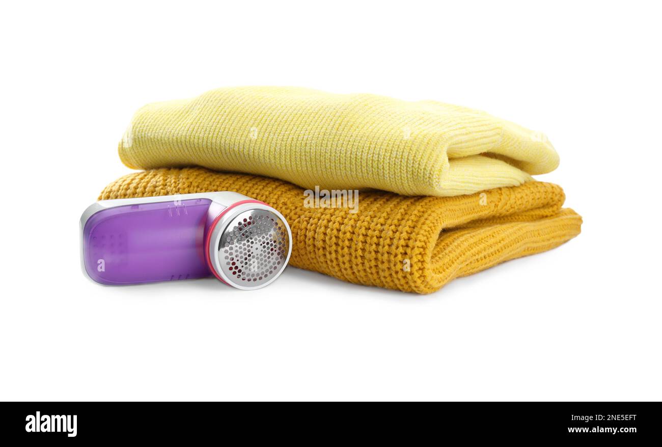 Modern fabric shaver and woolen clothes on white background Stock Photo ...