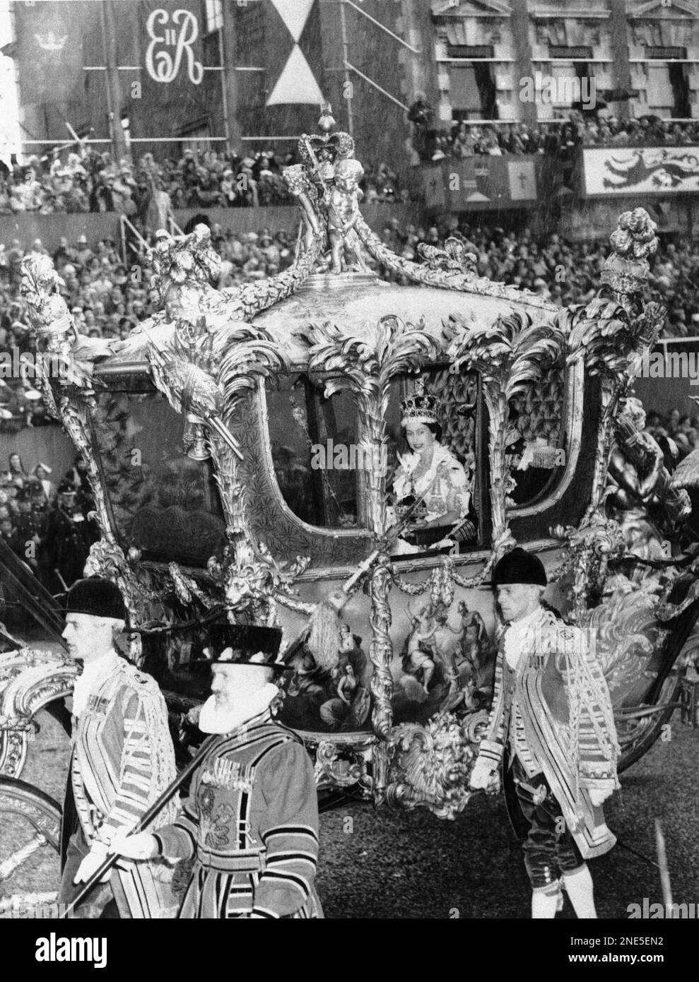 The Queen Elizabeth II smiles to acknowledge the cheers of the crowd as ...
