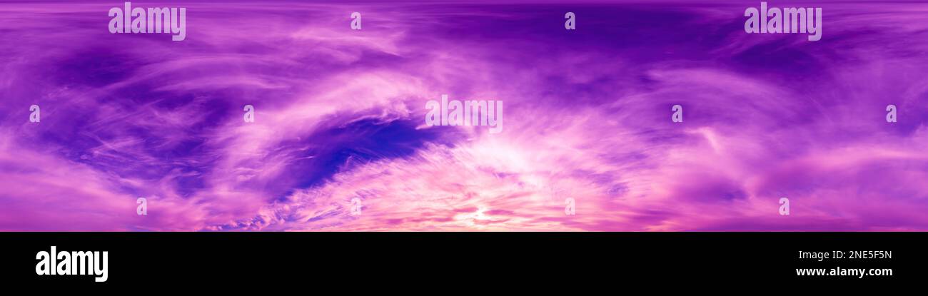 Panorama of a dark blue magenta sunset sky with golden Cumulus clouds ...