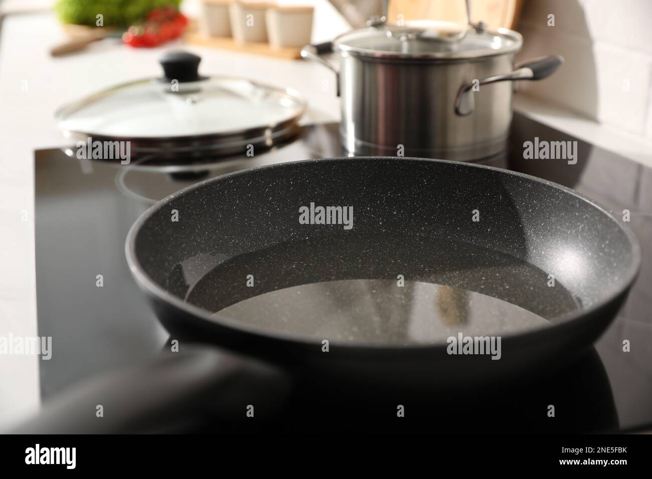 Frying pan with cooking oil on cooktop Stock Photo - Alamy