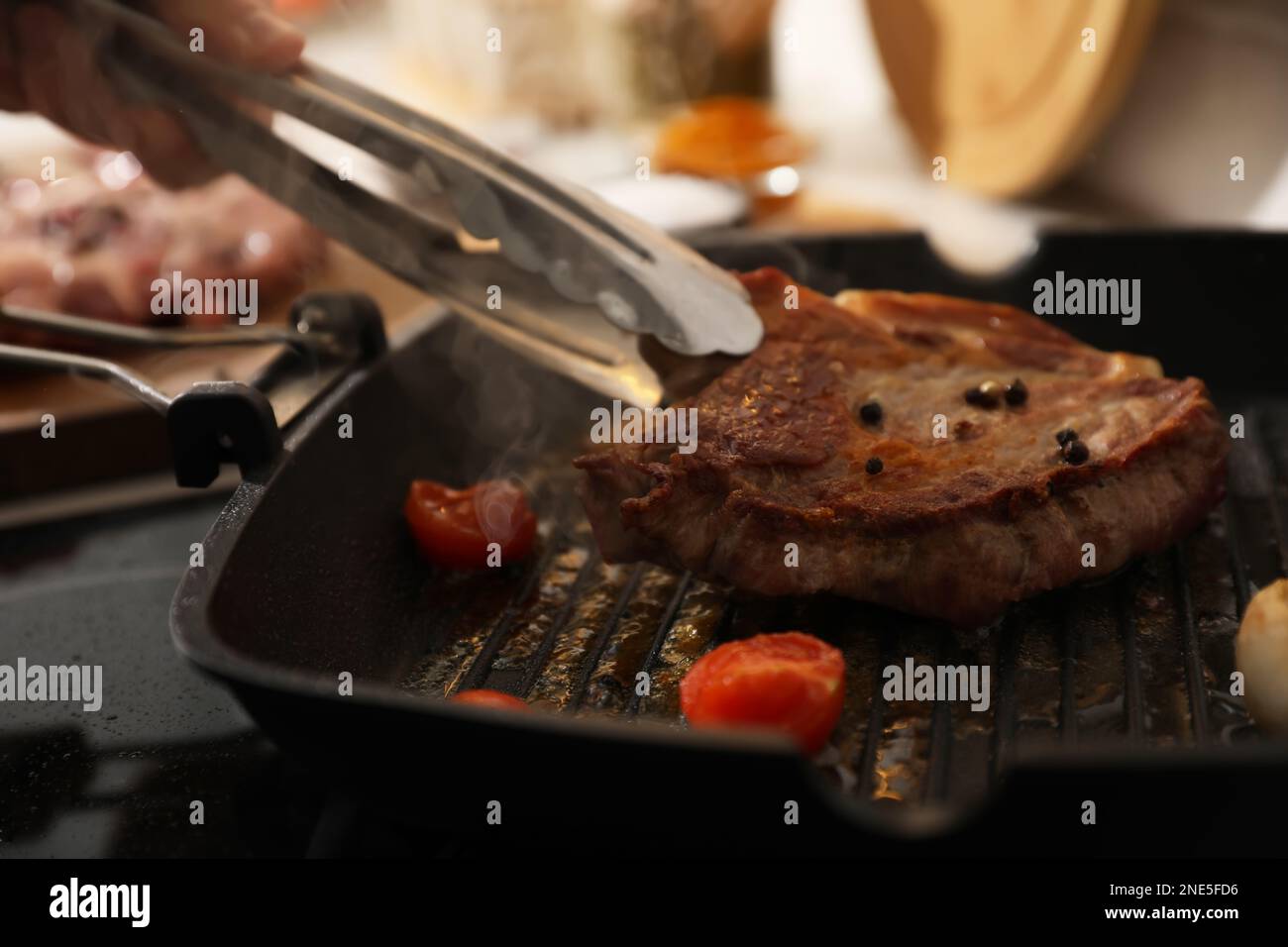 Man frying meat in pan hi-res stock photography and images - Alamy