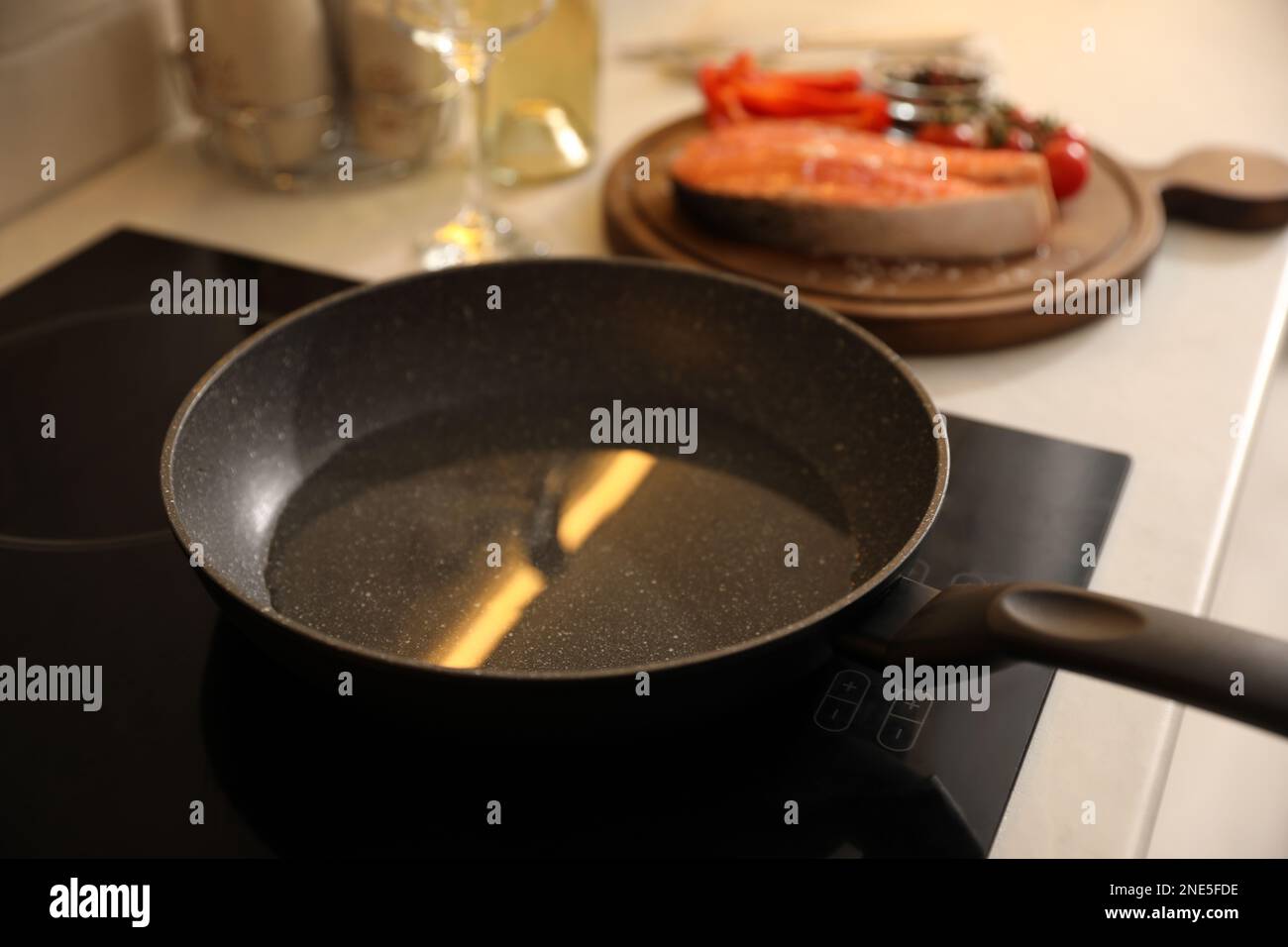 Frying pan with cooking oil on cooktop Stock Photo - Alamy