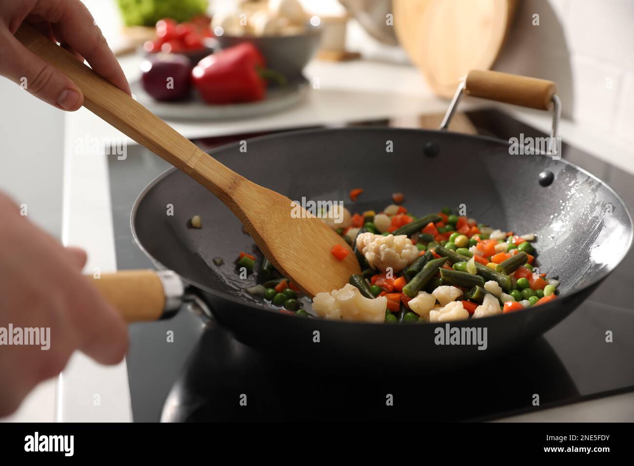 Man stirring mix of fresh vegetables in frying pan, closeup Stock Photo ...