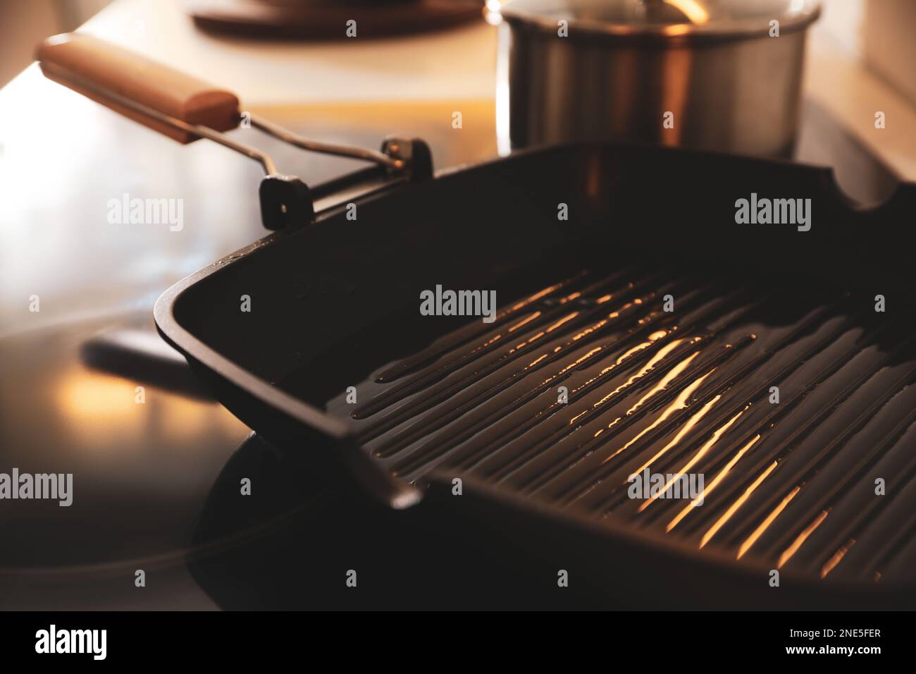 Frying pan with cooking oil on stove Stock Photo - Alamy