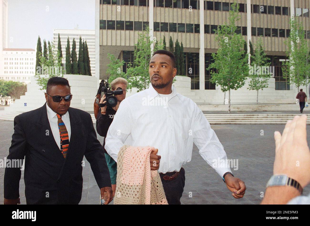 Rodney King is accompanied man into the Federal Courthouse in Los ...