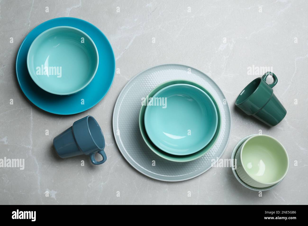 Set of elegant dishware on light grey marble table, flat lay Stock ...
