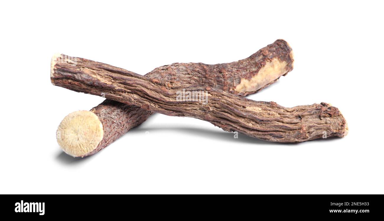 Dried sticks of liquorice root on white background Stock Photo - Alamy