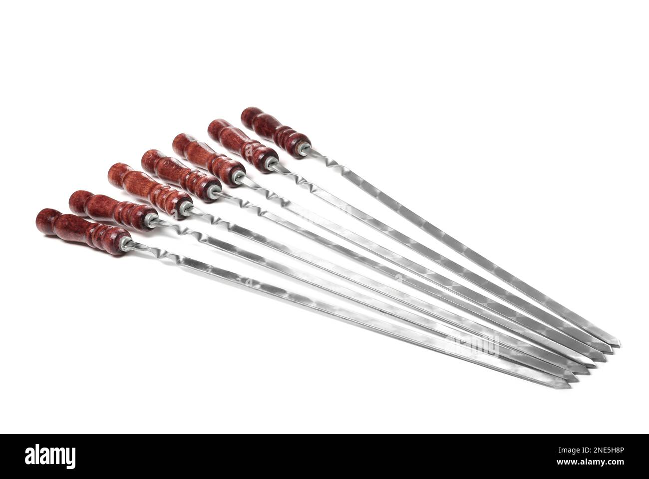 Metal skewers with wooden handle on white background Stock Photo - Alamy