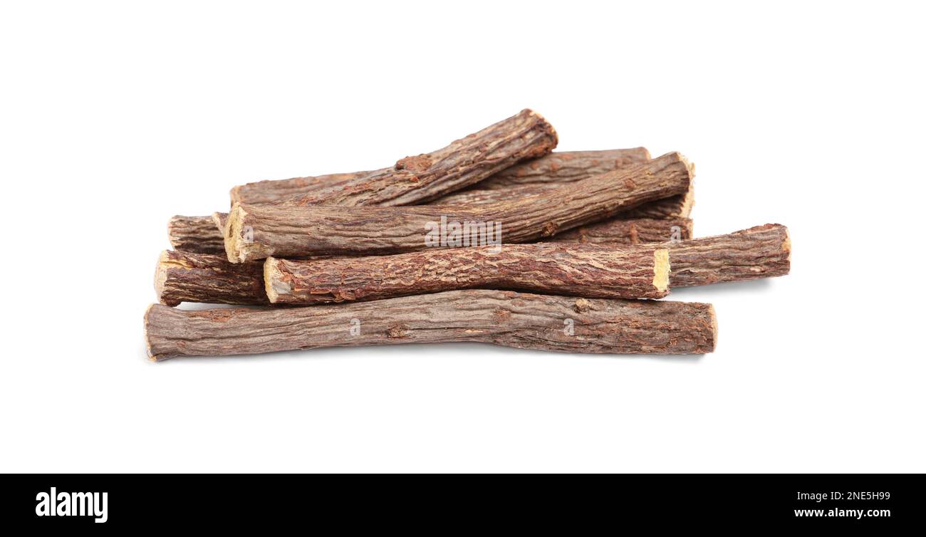 Dried sticks of liquorice root on white background Stock Photo - Alamy