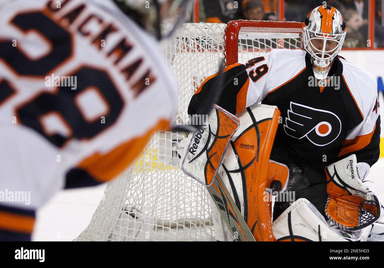 Philadelphia Flyers' Michael Leighton, right, blocks a shot by New York ...