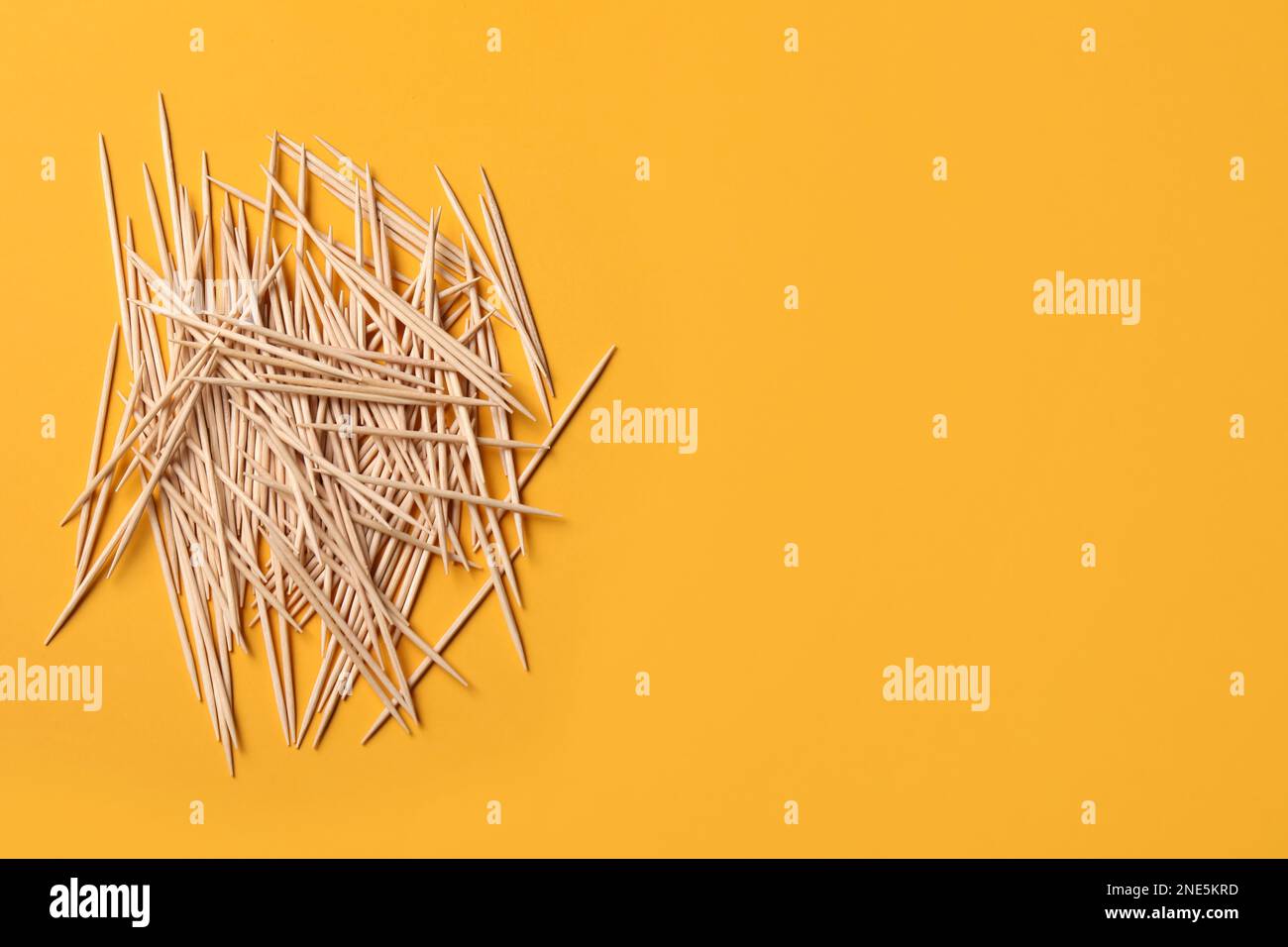 Wooden toothpicks on orange background, flat lay. Space for text Stock ...