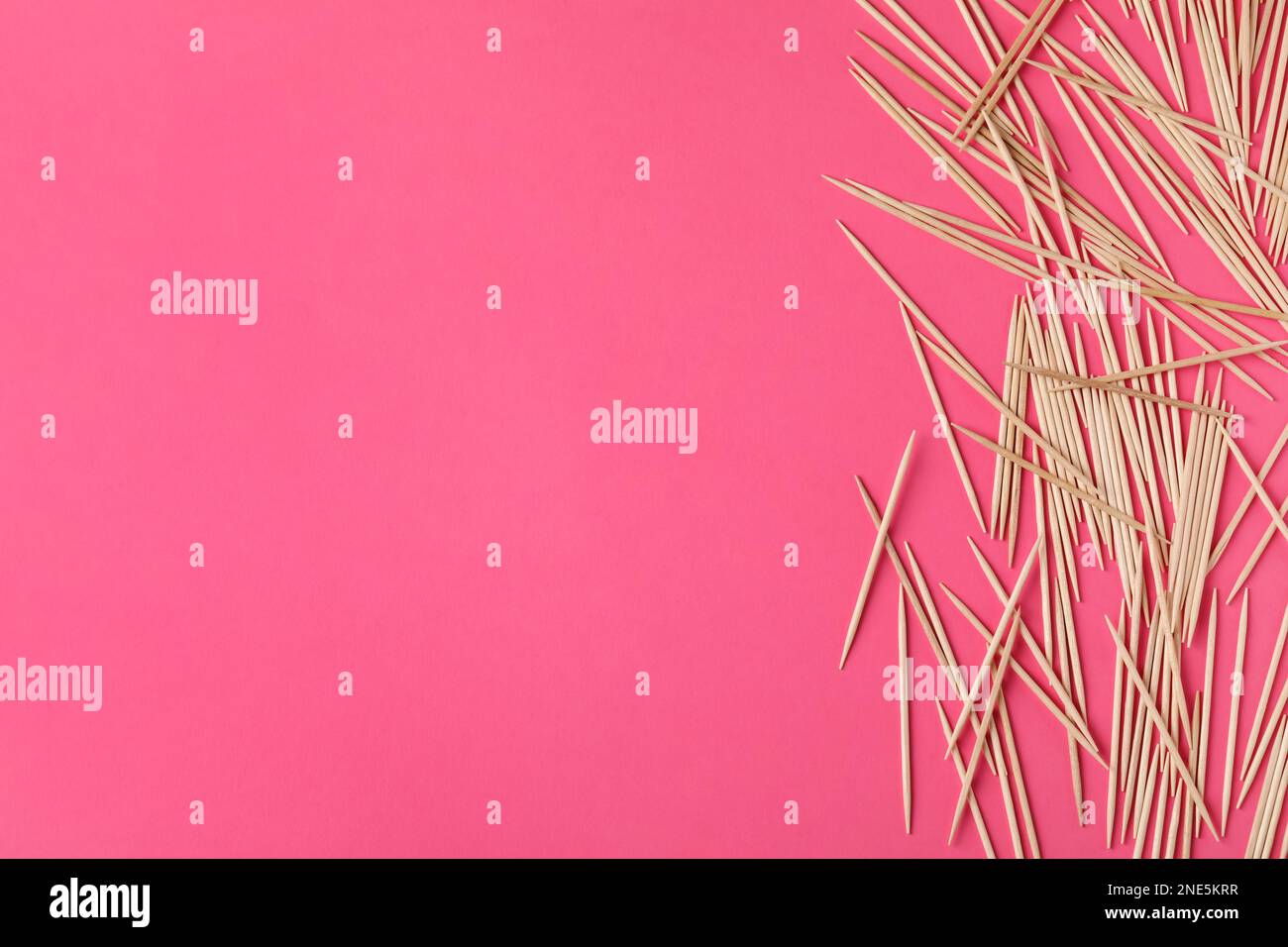 Wooden toothpicks on pink background, flat lay. Space for text Stock ...