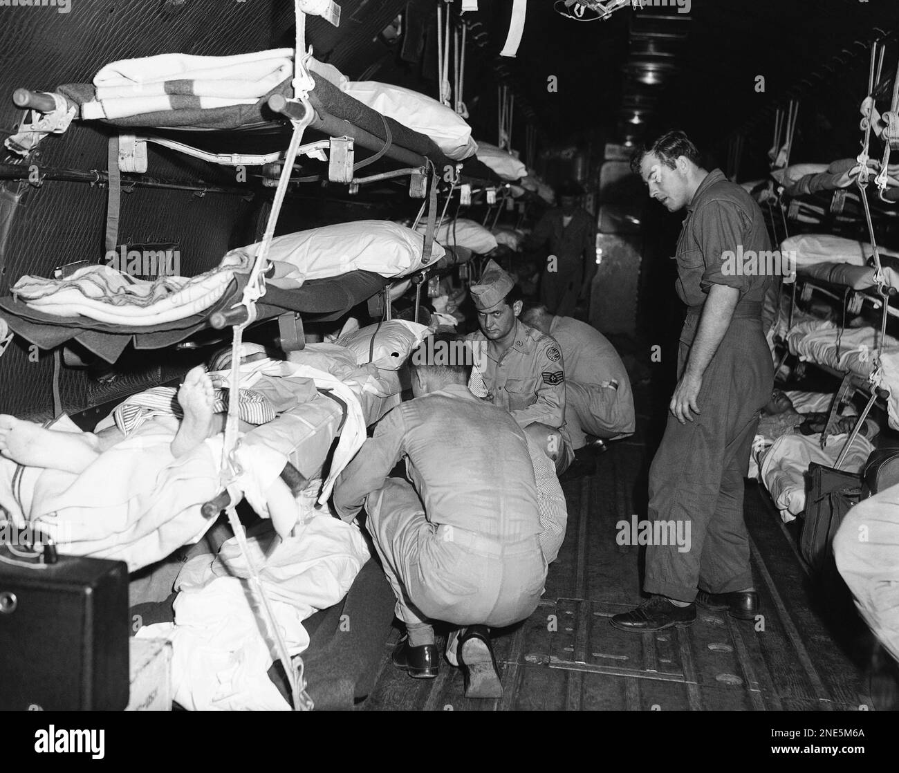 An Air Force sergeant adjusts the bunk of one of the U.S. wounded from ...