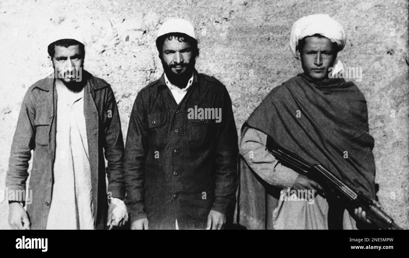 Two Afghan army lieutenants stand with their guerrilla guard at a ...