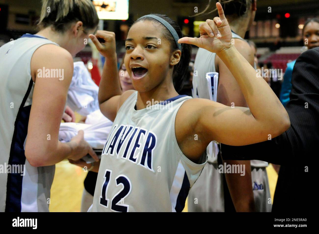 Xavier's Alesia Barringer (12) celebrates after beating Temple 57-55 in ...