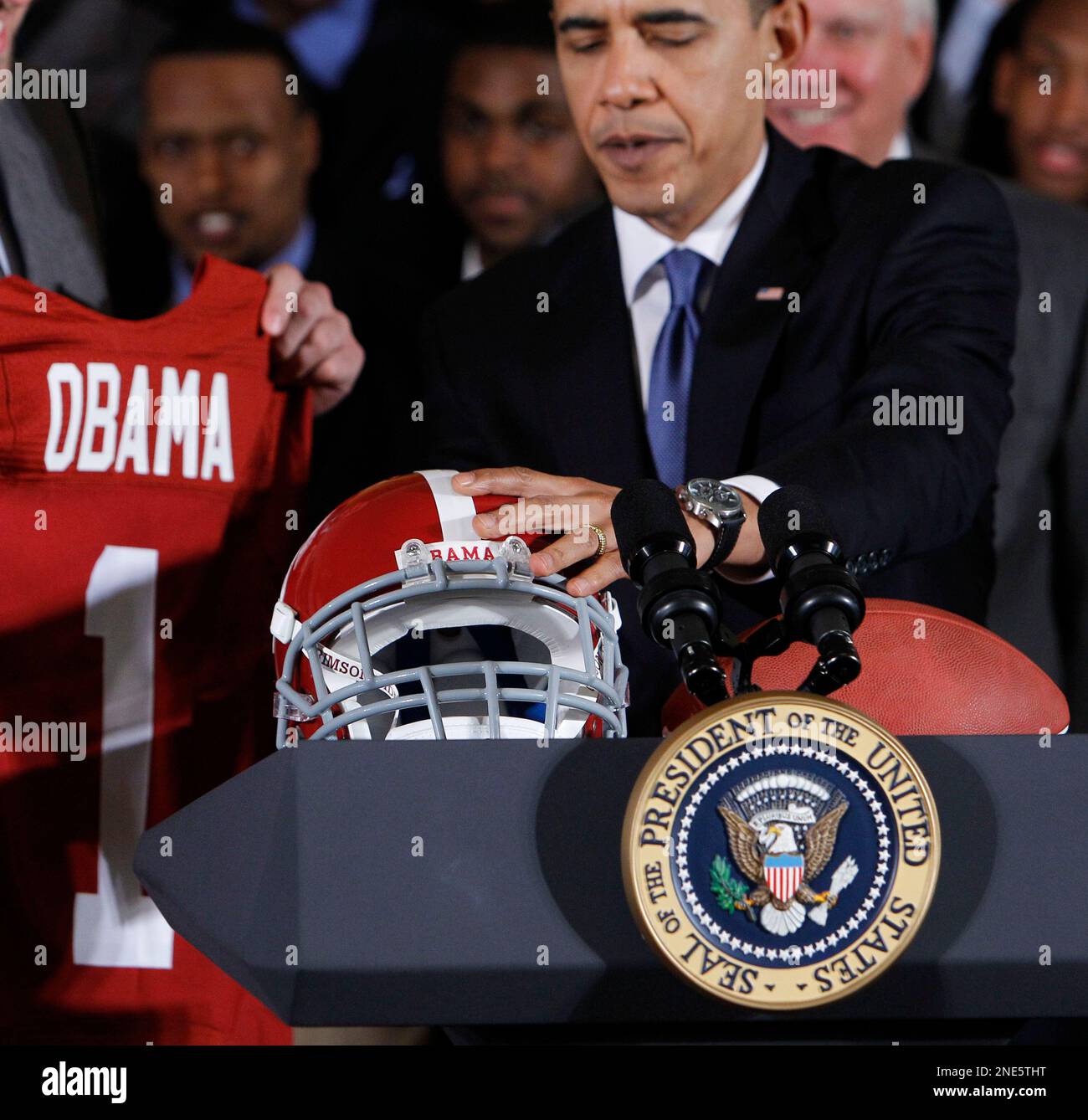 President Barack Obama places a University of Alabama football helmet ...