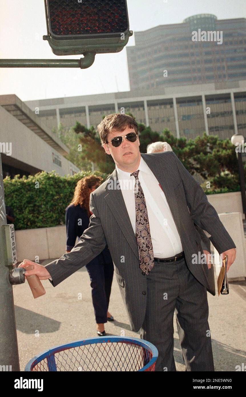 Los Angeles police officer Laurence Powell waits for a green light ...