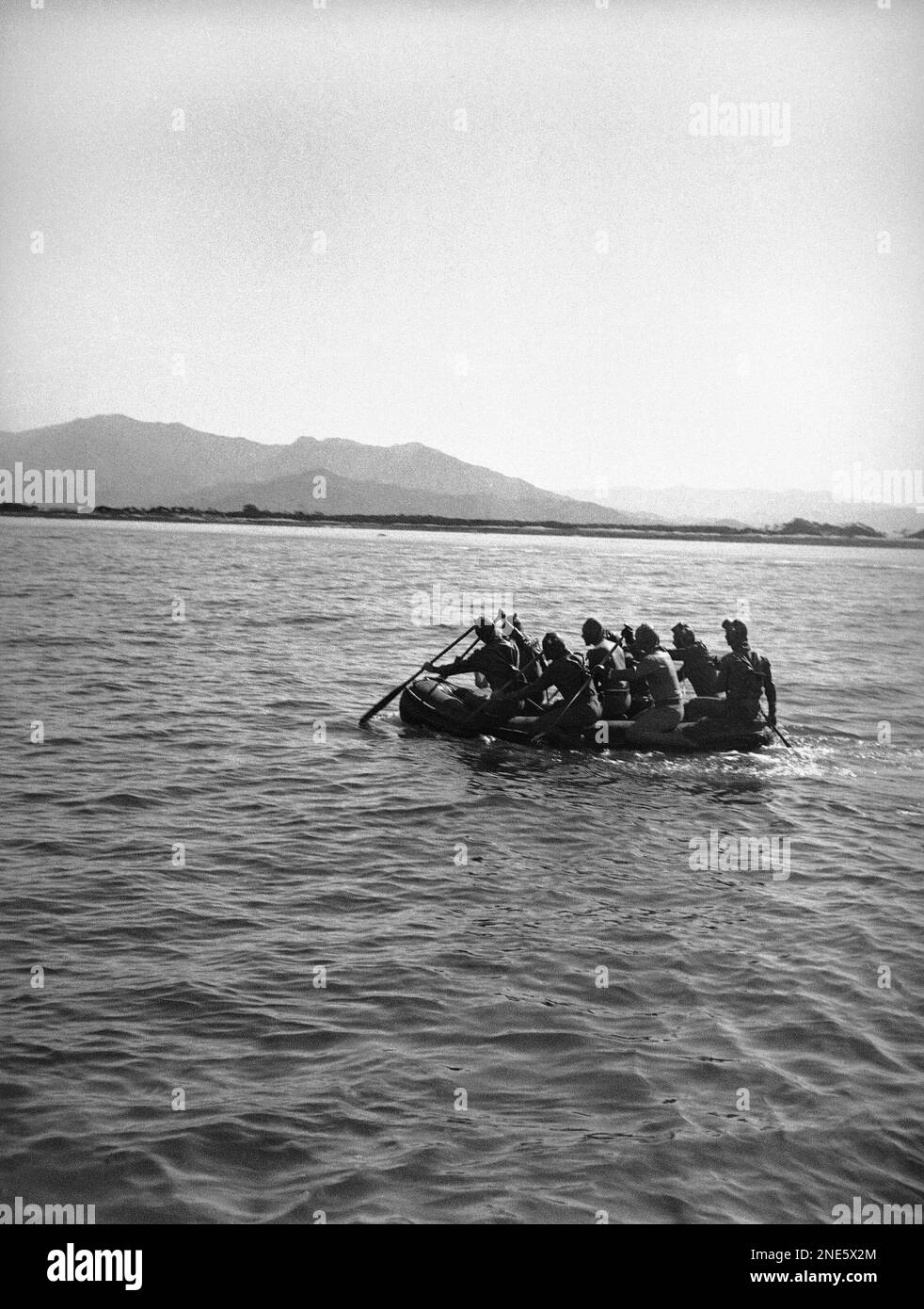 A heavily loaded rubber raft carrying Navy ?Frogmen? head for shore at ...