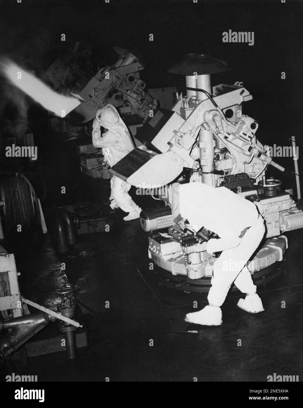 U.S. Navy rocket gunners, clad in asbestos suits for protection against ...
