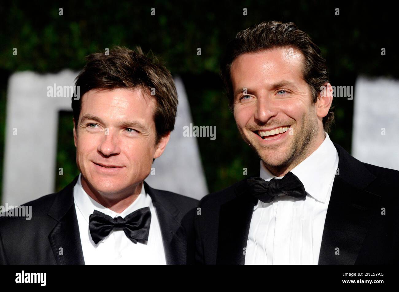 Jason Bateman, left, and Bradley Cooper arrive at the Vanity Fair Oscar ...