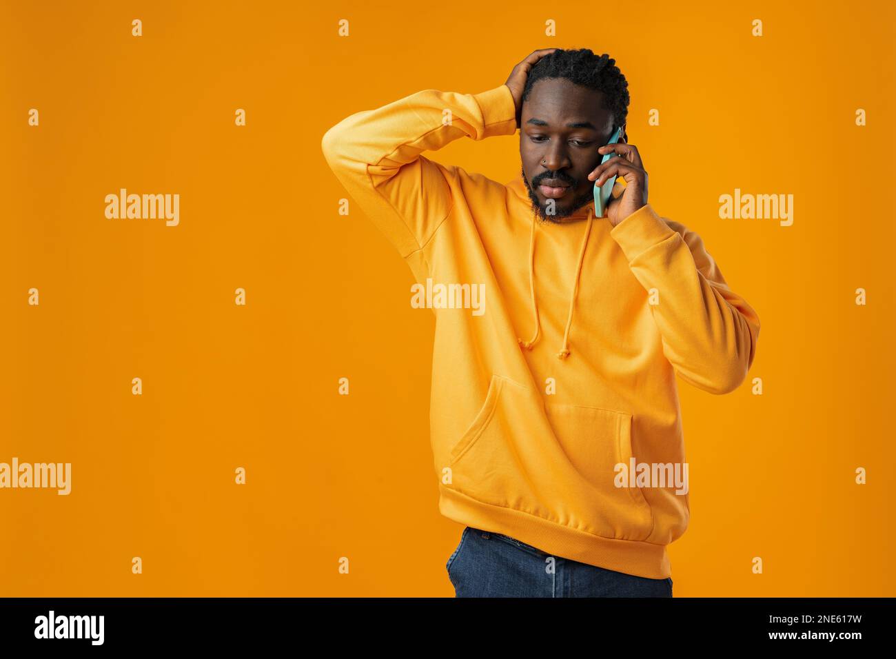Young black man making a phone call against yellow background Stock ...