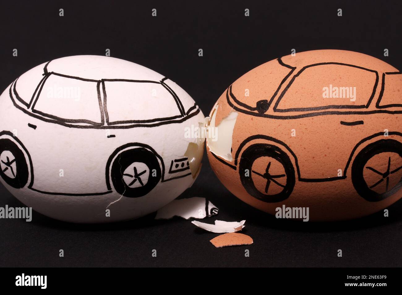 brown and white chicken egg painted as cars, car accident Stock Photo ...