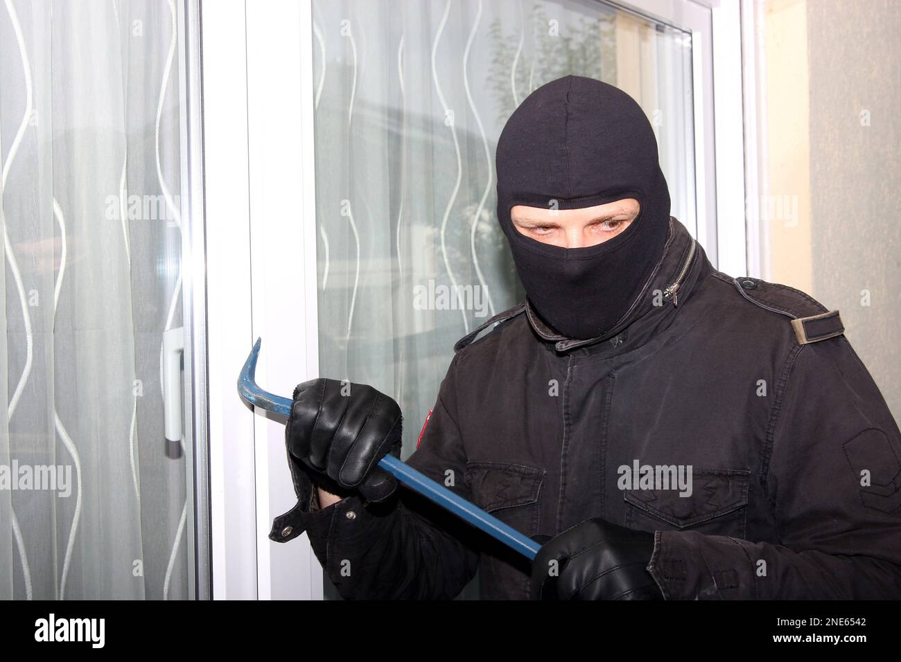 masked burglar with crowbar on a window Stock Photo - Alamy
