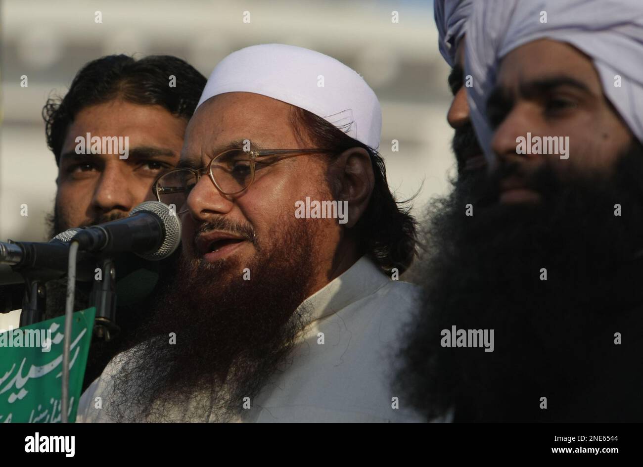 Hafiz Muhammad Saeed, center, the leader of a banned Islamic group ...