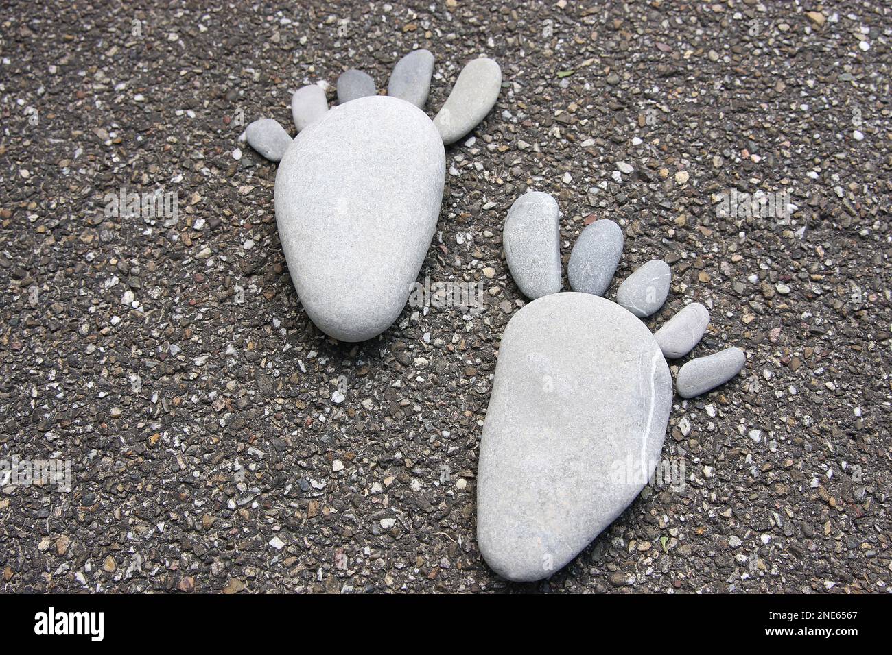 stone feet on asphalt Stock Photo - Alamy