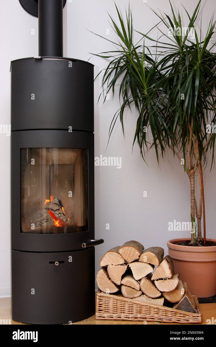 Scandinavian wood stove with stacks of wood Stock Photo - Alamy