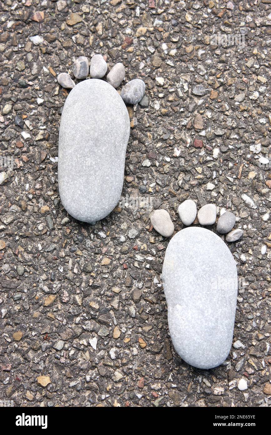 stone feet on asphalt Stock Photo - Alamy