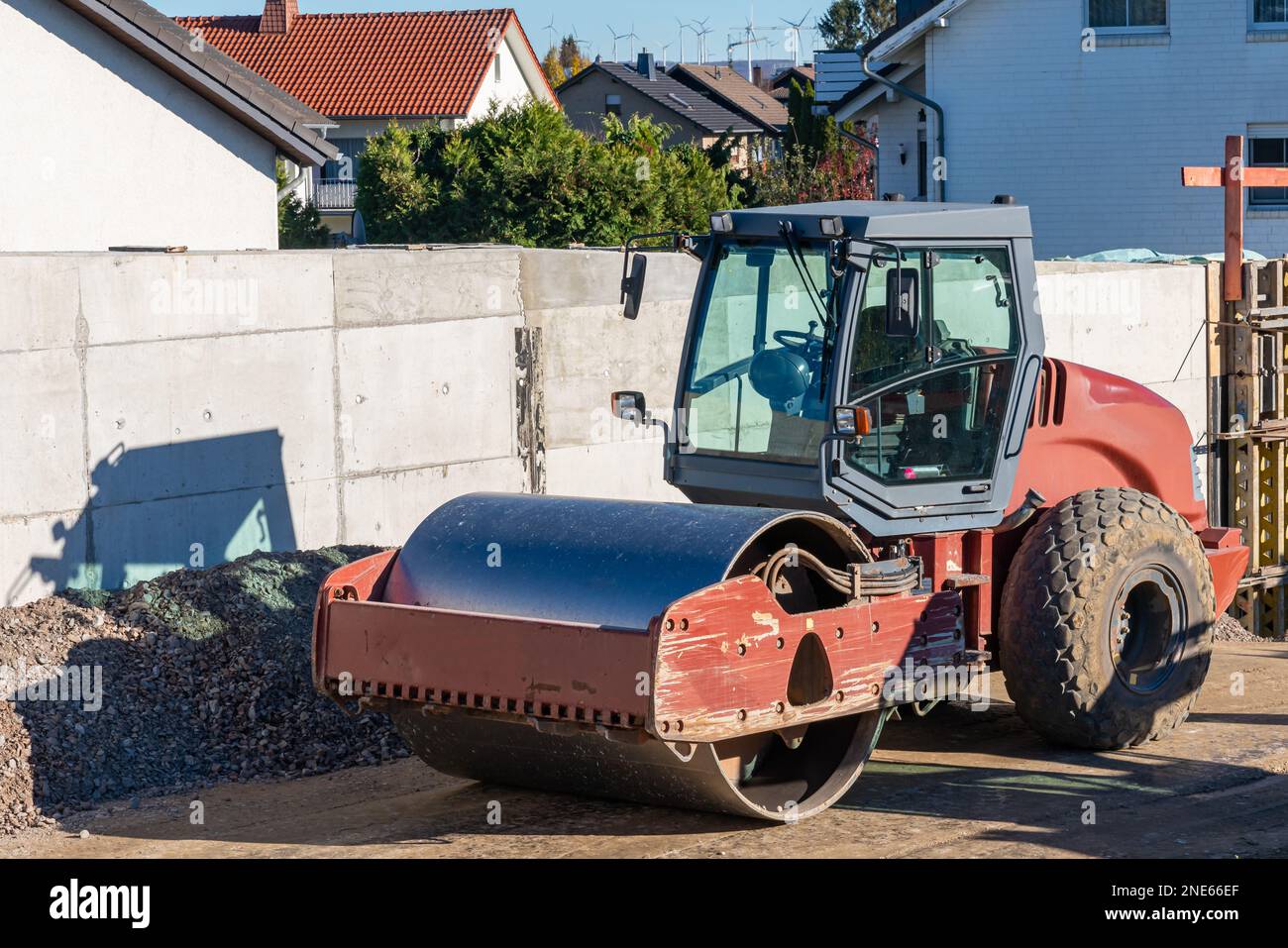 The compact road roller standing on a construction site near a concrete ...